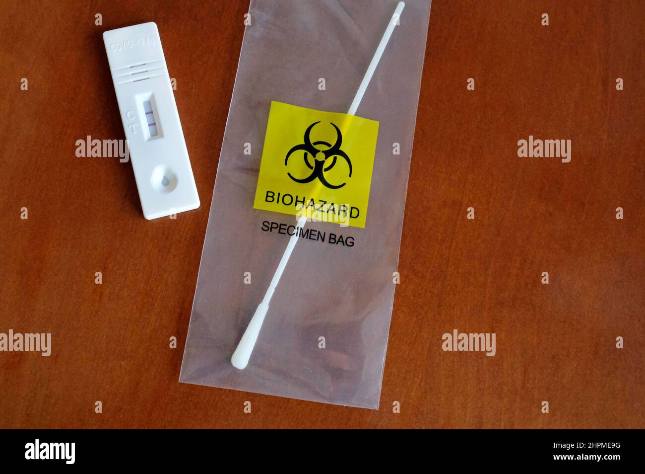 Coronavirus (COVID-19) rapid test with positive result next to a nasal ...