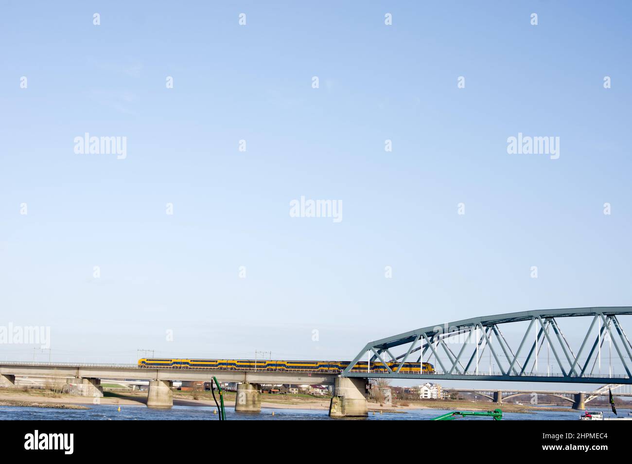 Train on rail bridge over the river Waal in Nijmegen in the Netherlands ...