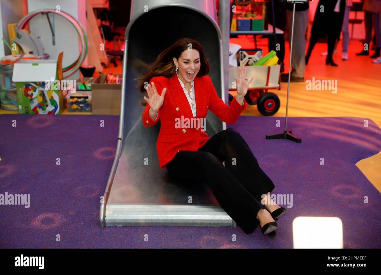 The Duchess of Cambridge comes down a slide during a visit to the LEGO ...