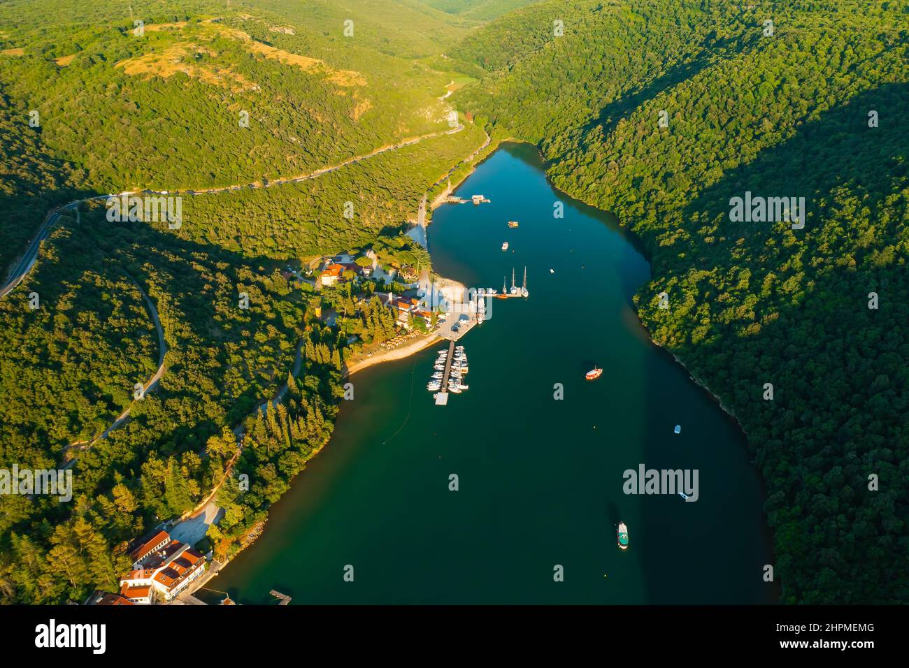 Oyster farm in Lim bay leading to Adriatic sea past mountains covered ...