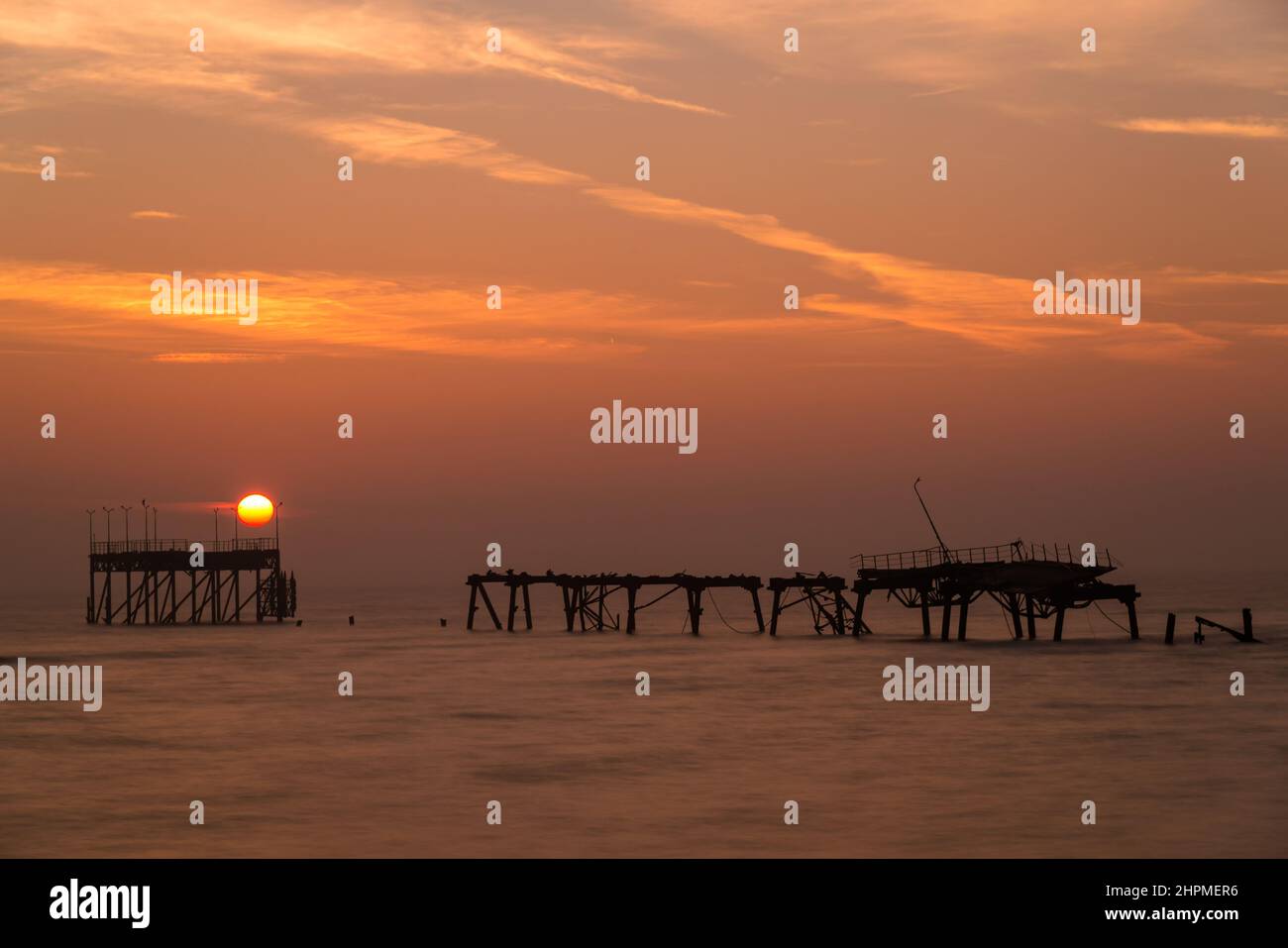 Beautiful sunrise over the old broken bridge. Low light long exposure ...