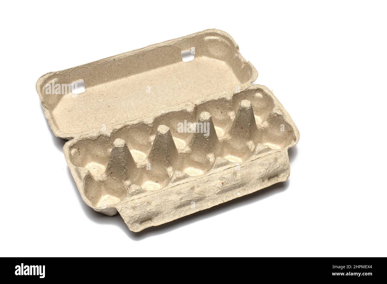 Close up of an empty open cardboard egg carton box on white background ...