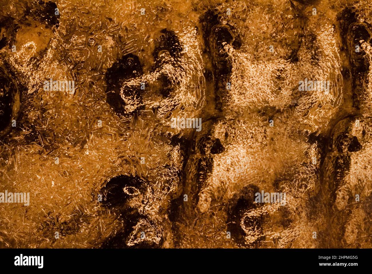 Photo of orange toned frozen wooden coal covered in ice surface texture ...