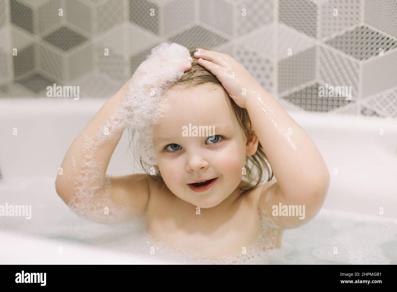 Child bathing. Little baby taking bath, closeup face portrait of ...