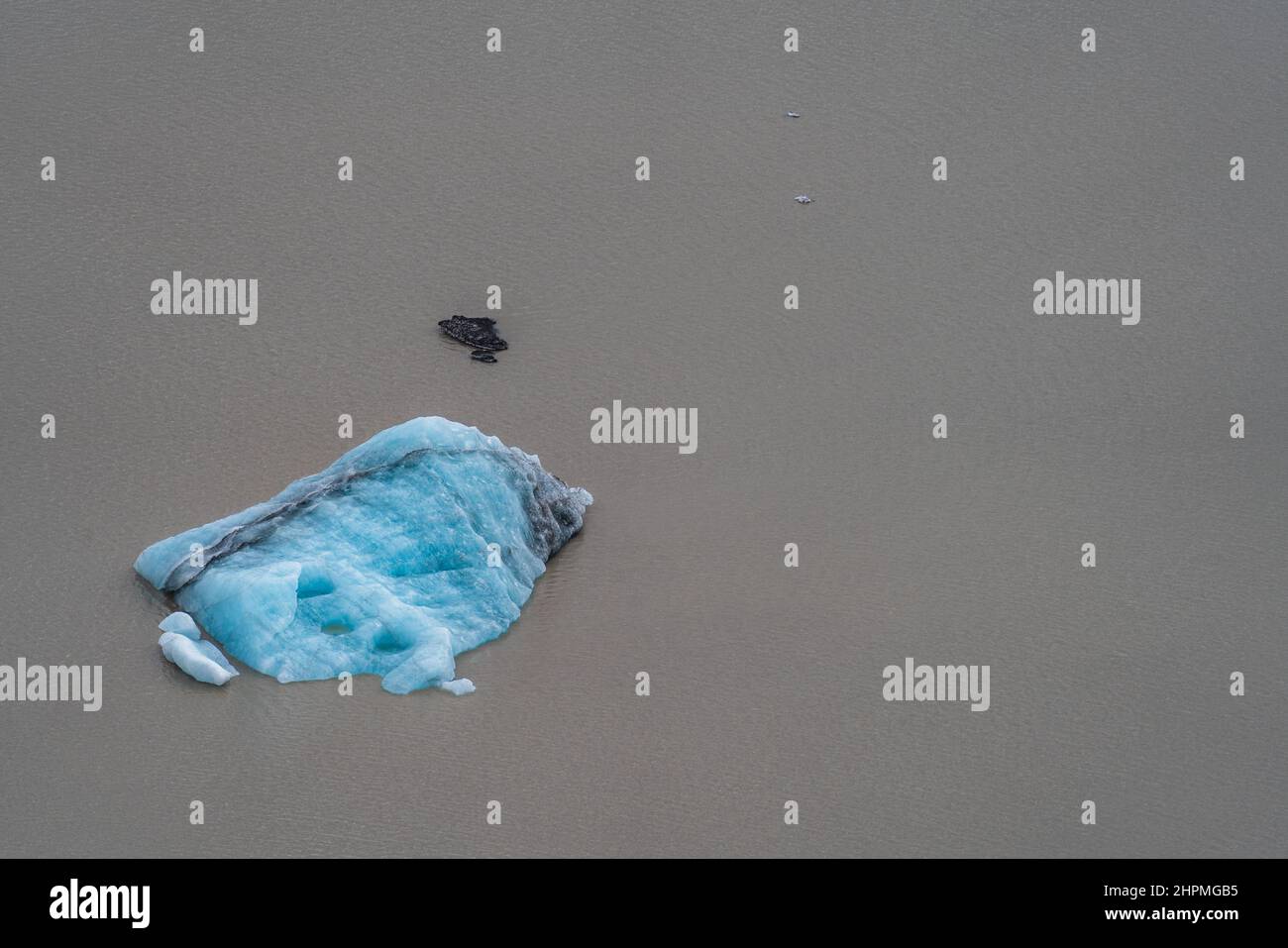 Iceberg floating over the brown glacier water Stock Photo - Alamy