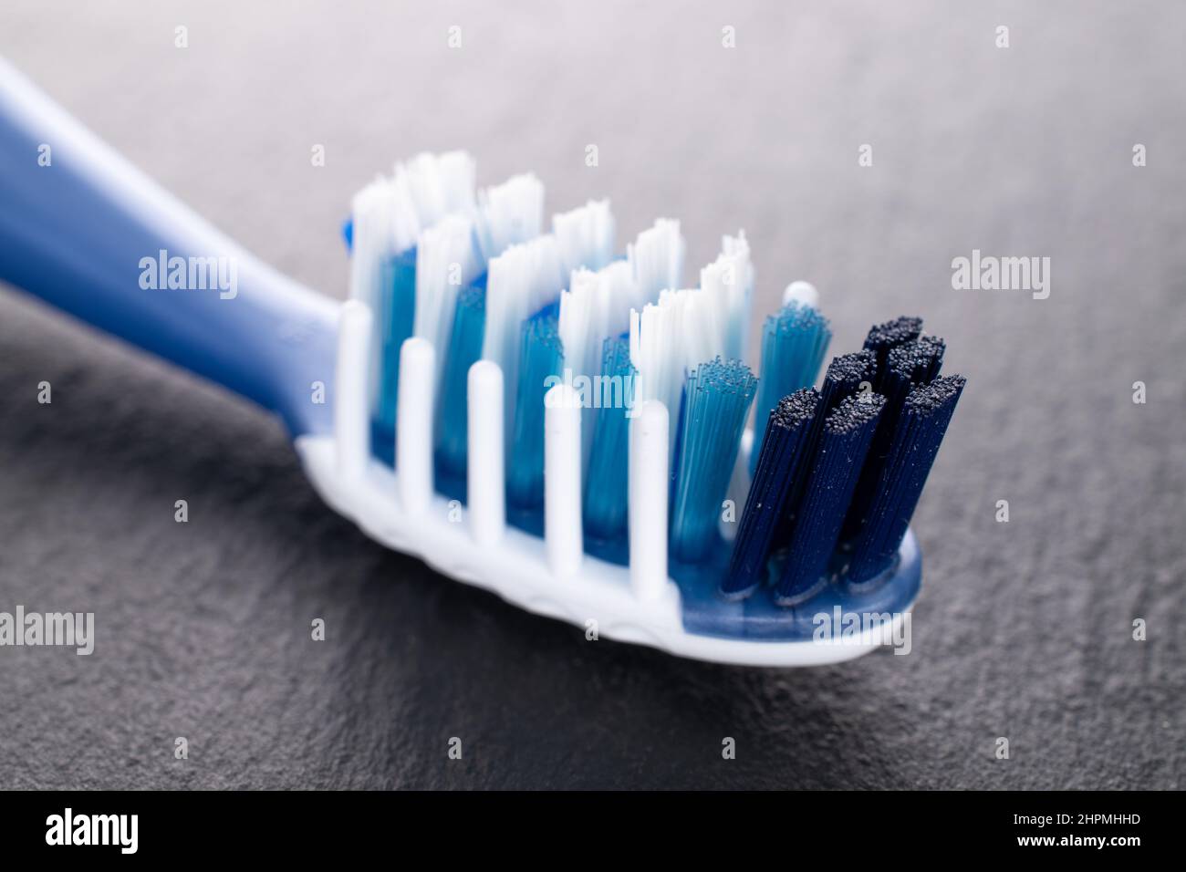 One toothbrush on a slate stone, close-up Stock Photo - Alamy