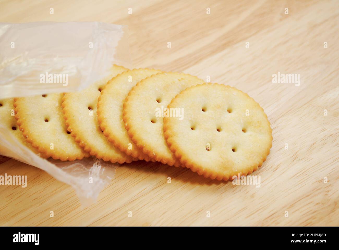 Package round crackers falling onto a wooden table hi-res stock ...