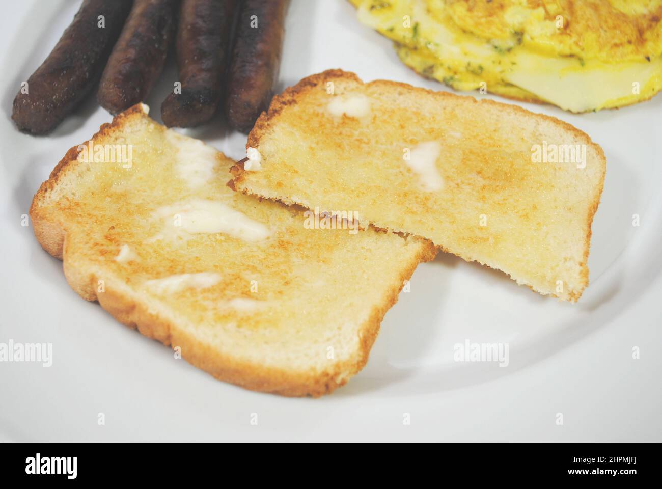 A Slice of Buttered Toast Cut in Half as Part of a Hardy Breakfast ...