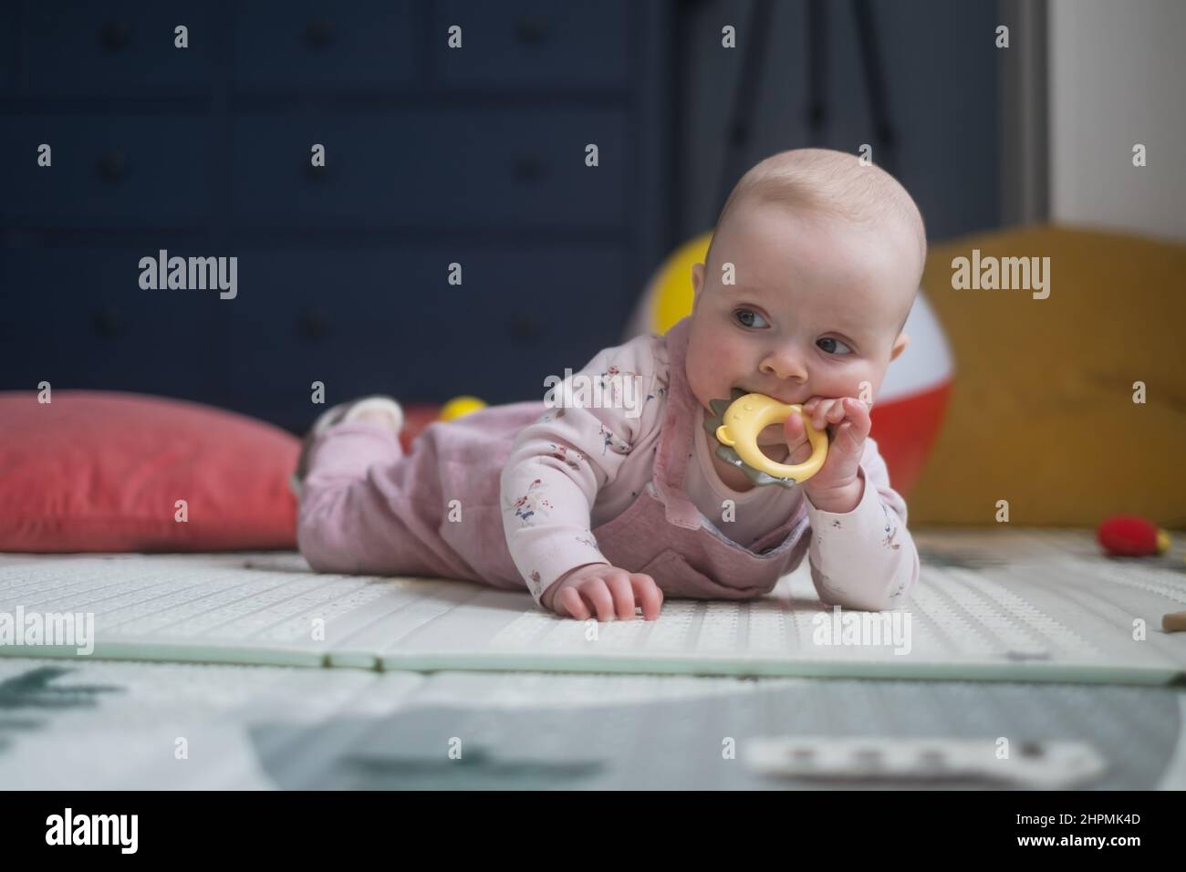 six months old caucasian baby on the floor with a toy Stock Photo - Alamy
