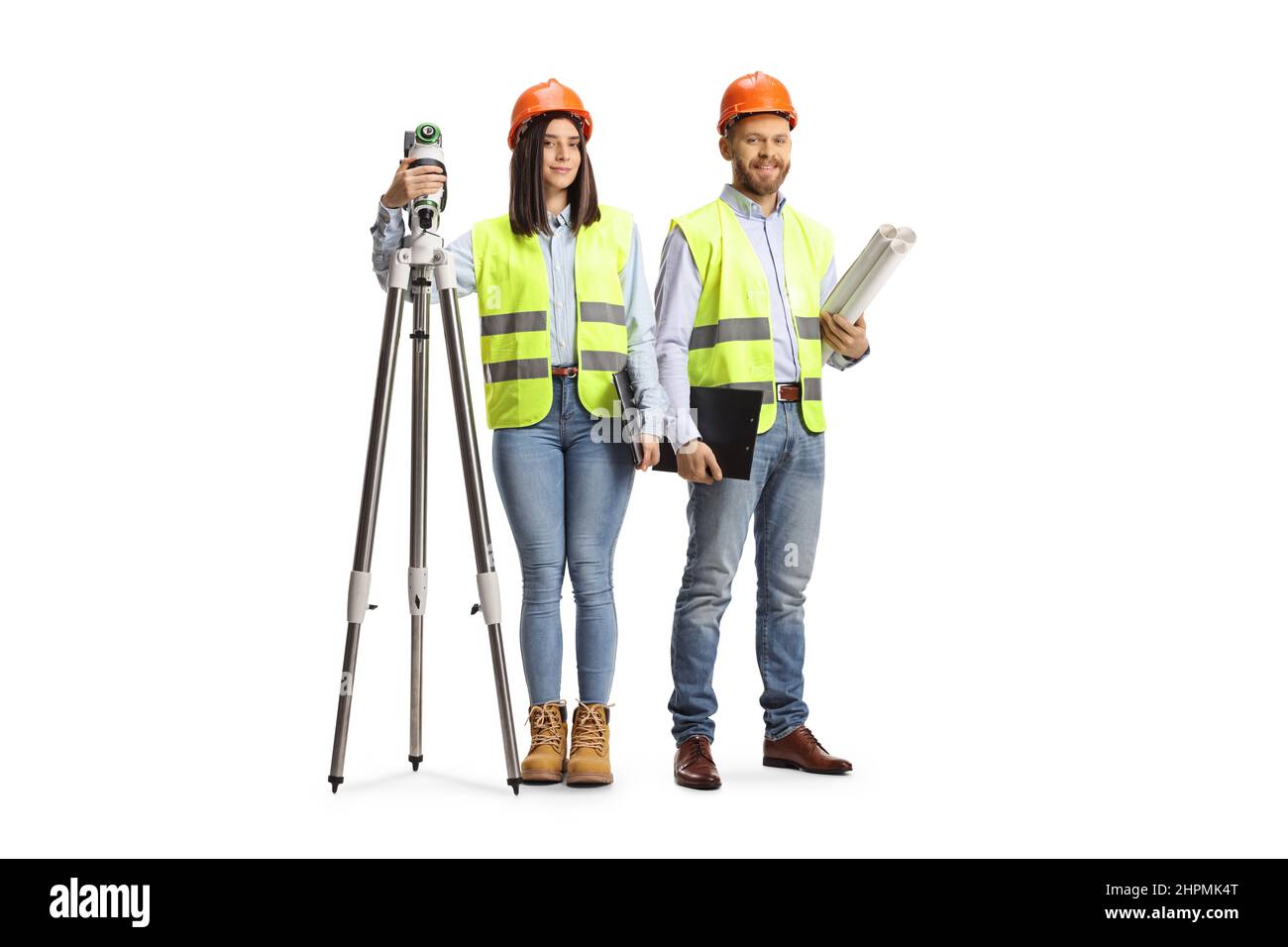 Female geodetic surveyor with a measuring device and a male engineer ...