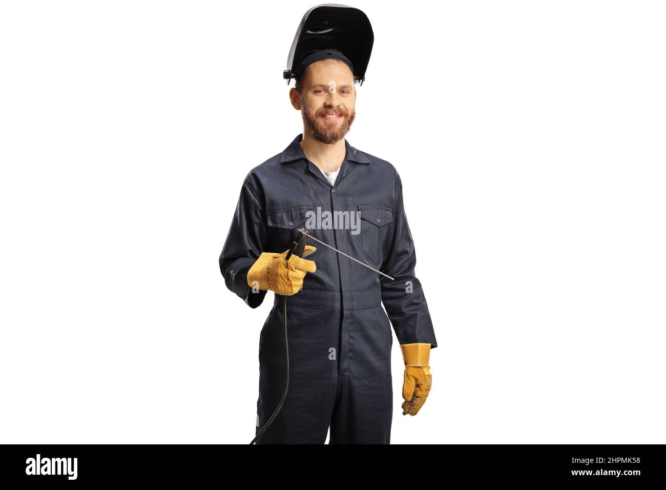 Smiling welder with a shield and a welding machine isolated on white ...