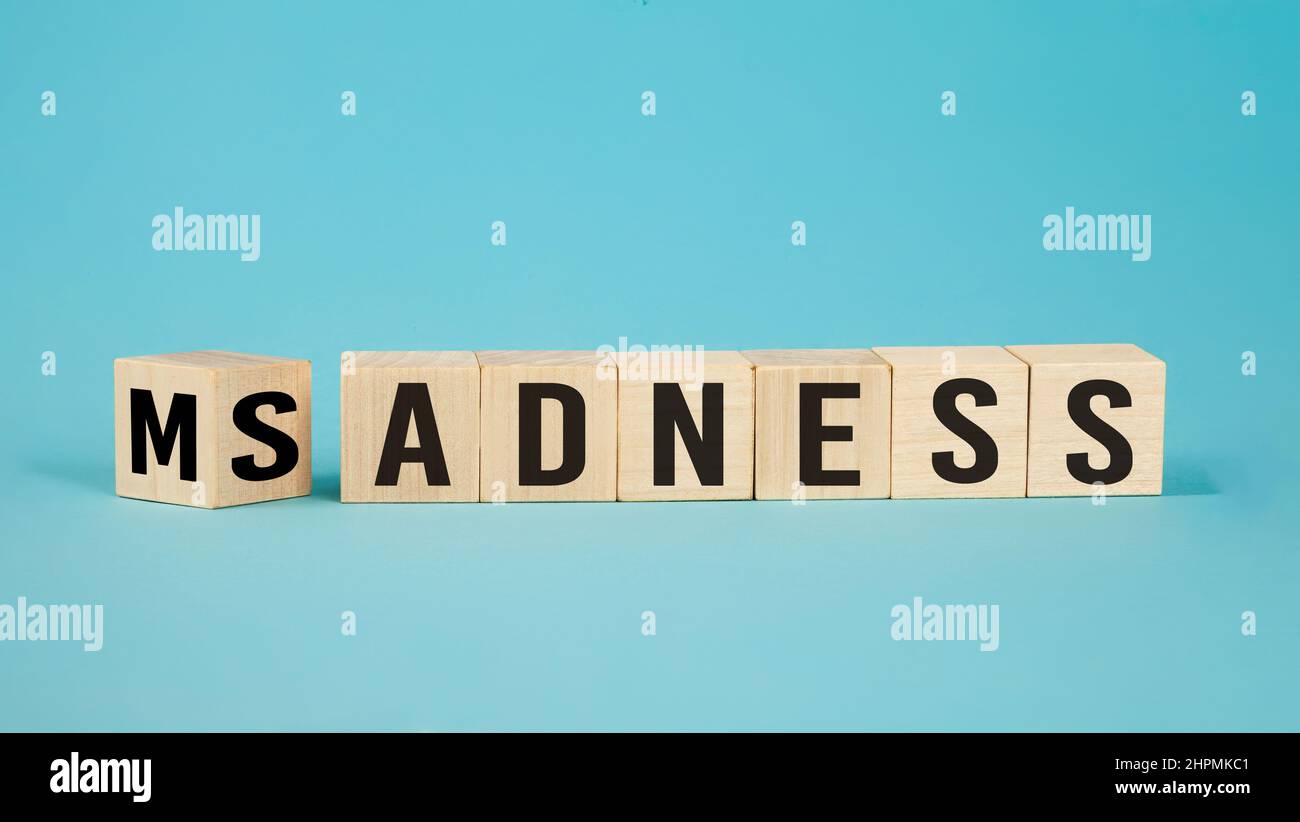 Madness and sadness on wooden cubes, dice or blocks with madness and ...