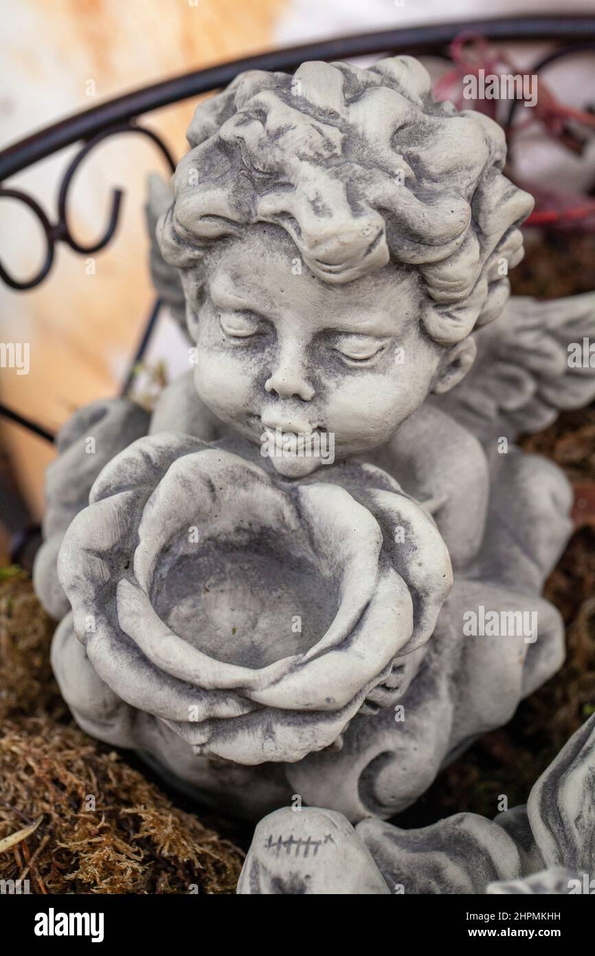 Small angel figurine with flower pot Stock Photo - Alamy