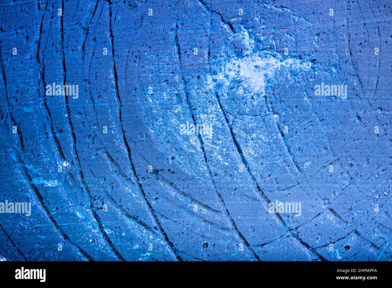 Photo of blue toned frozen cracked ice lines on metal surface texture ...