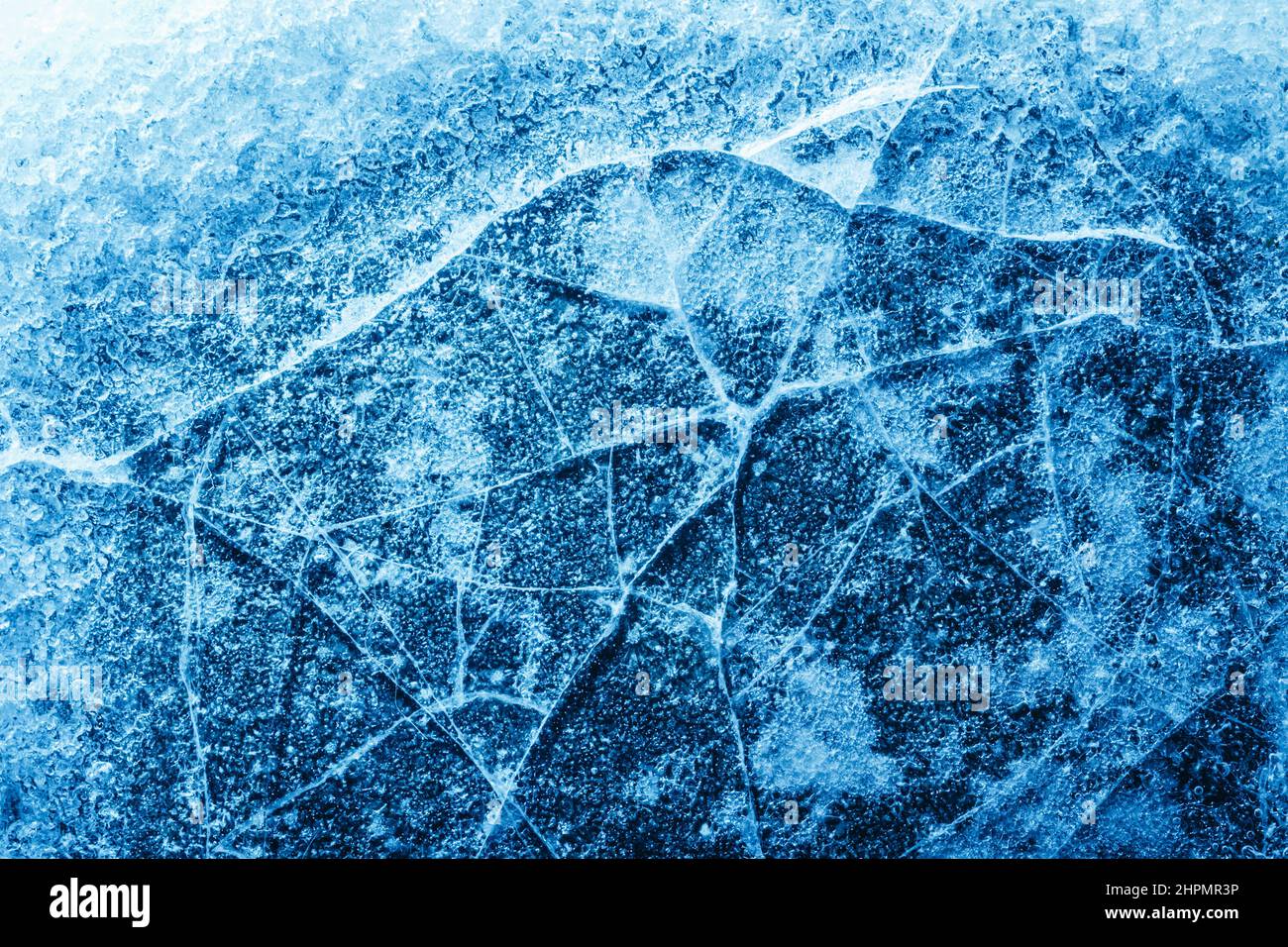 Photo of blue toned frozen cracked ice with snow surface texture Stock ...