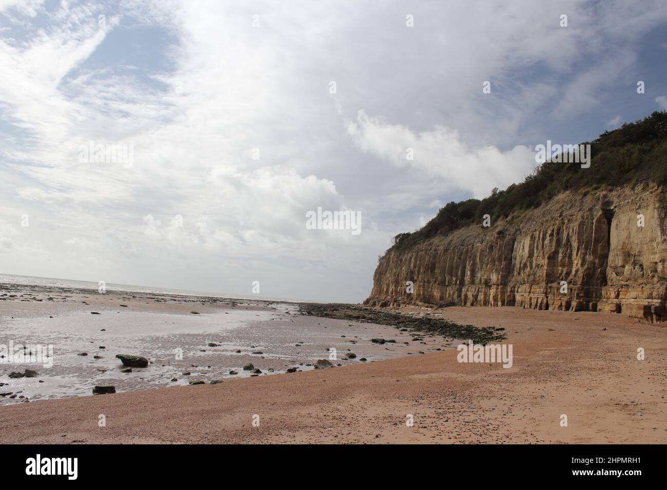 Pett Level Beach with its commanding cliff face and submerged pre ...