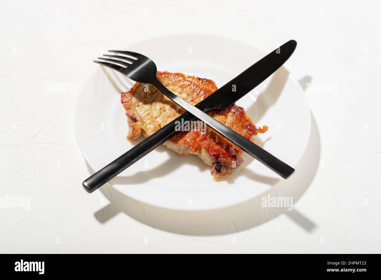 Stop meat concept. Stop eating animal products. A piece of fried meat ...