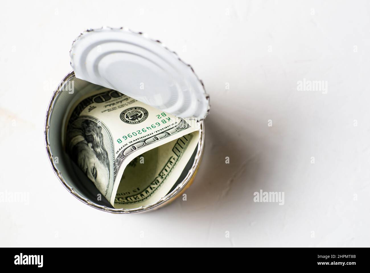 Dollars in an open tin can. Safeguarding cash, stash concept. Time to ...
