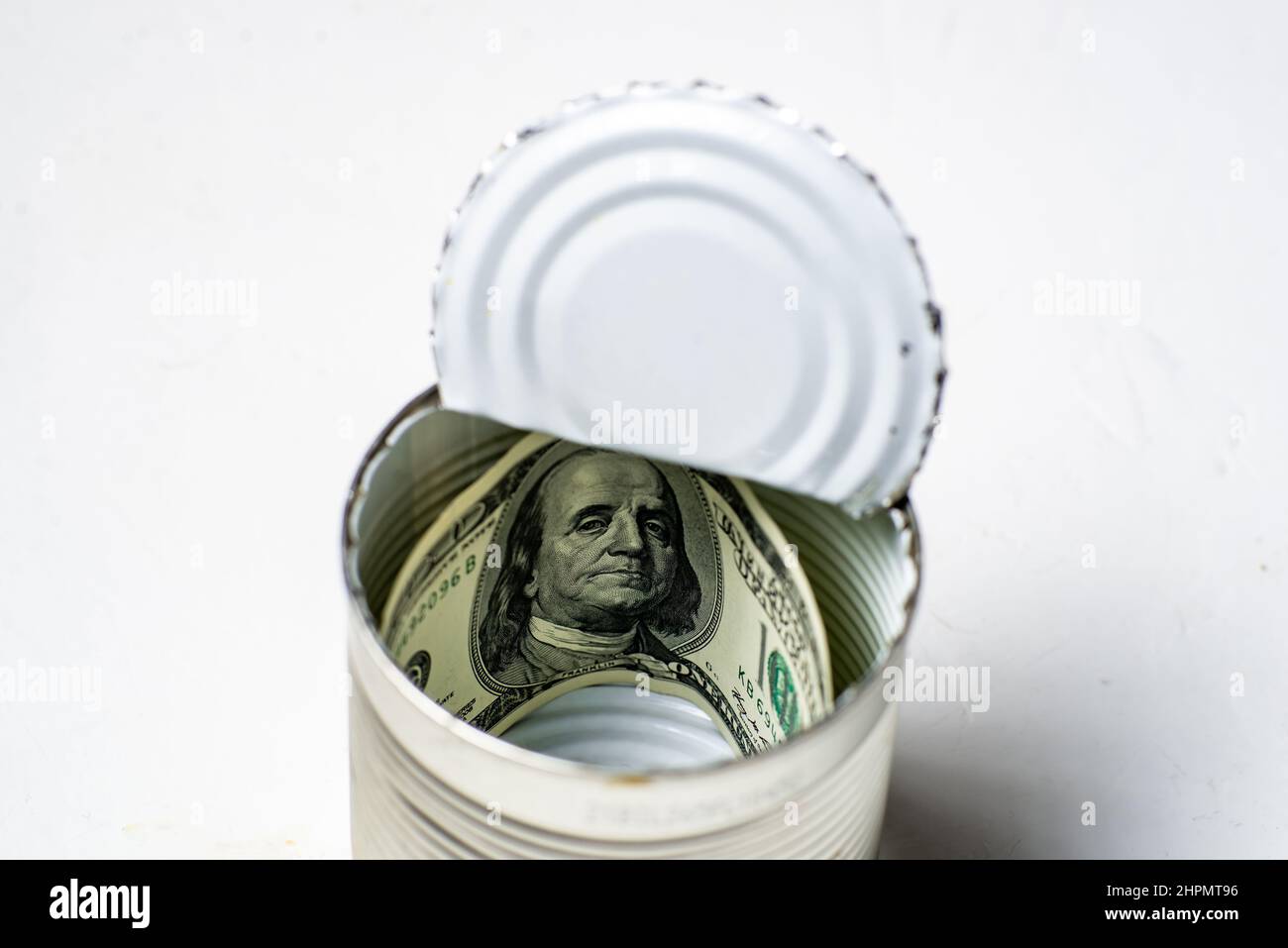 Dollars in an open tin can. Safeguarding cash, stash concept. Time to ...