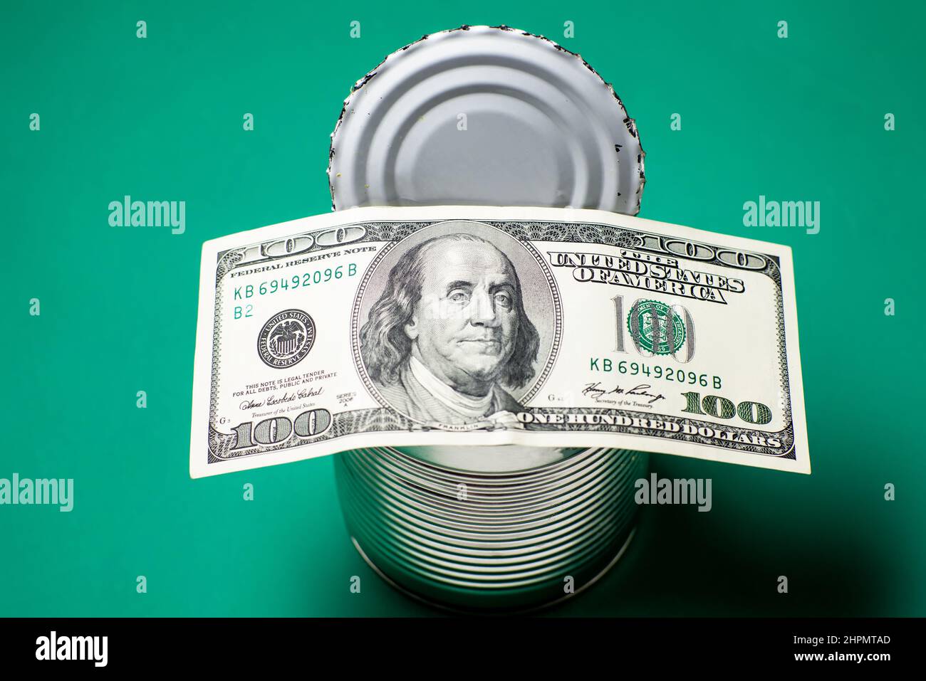 Dollars in an open tin can. Safeguarding cash, stash concept. Time to ...