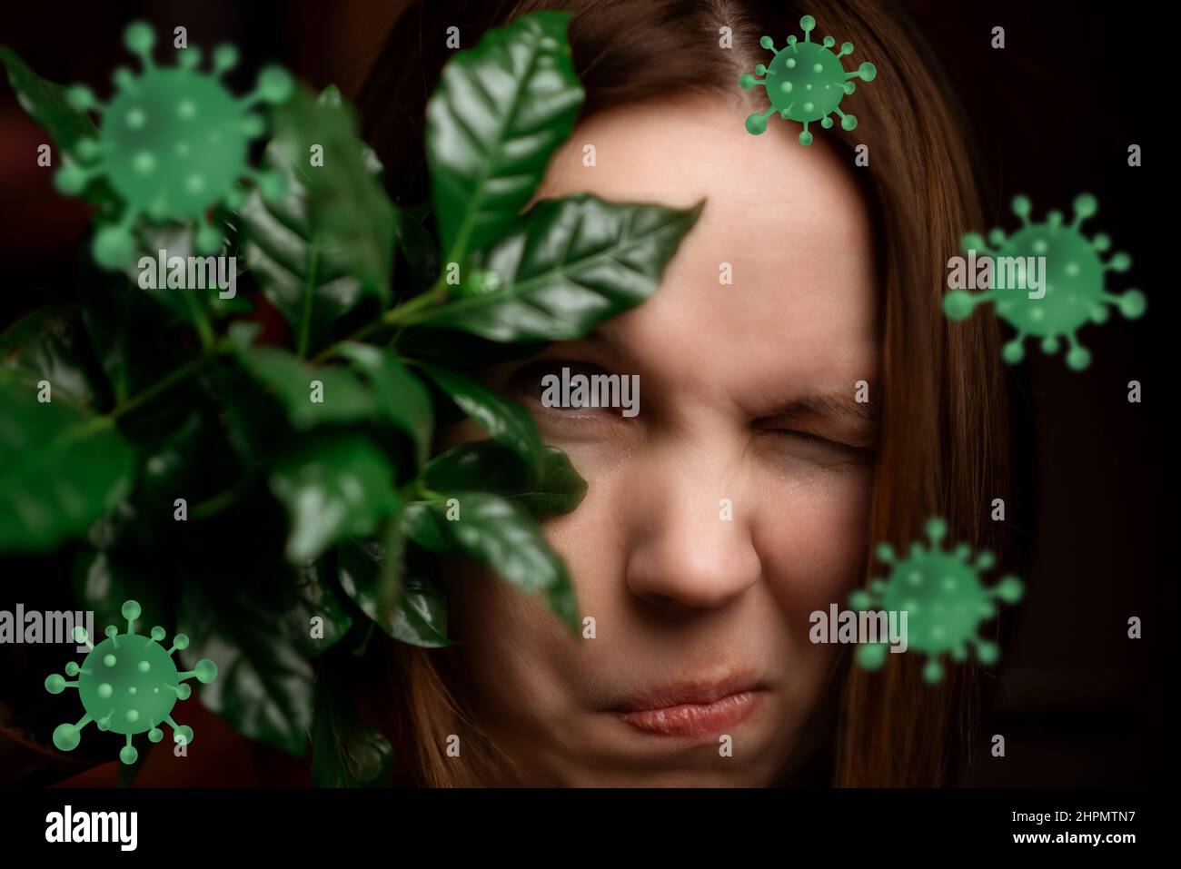 Woman with a plant near her face and coronavirus molecules around ...
