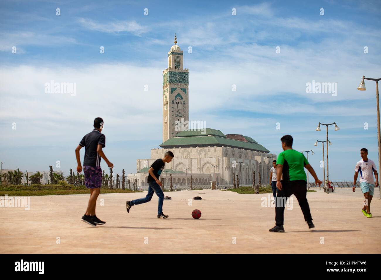 Kids playing football in street hi-res stock photography and images - Alamy