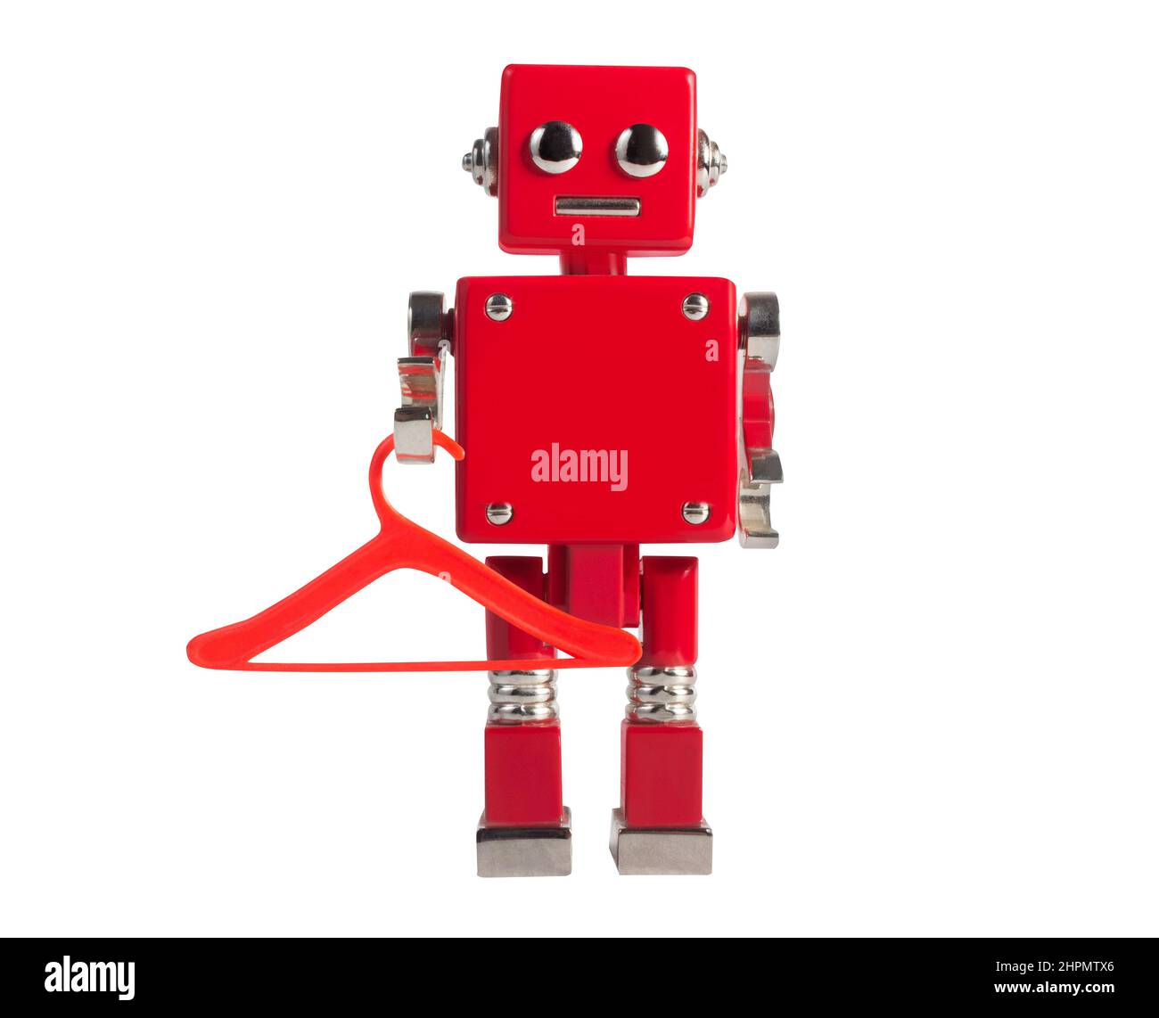Isolated photo of red colored metal miniature robot toy standing with ...