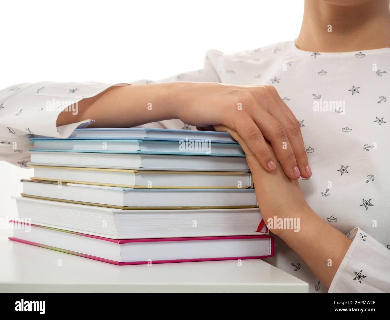 Stack of books with hands on it Stock Photo - Alamy