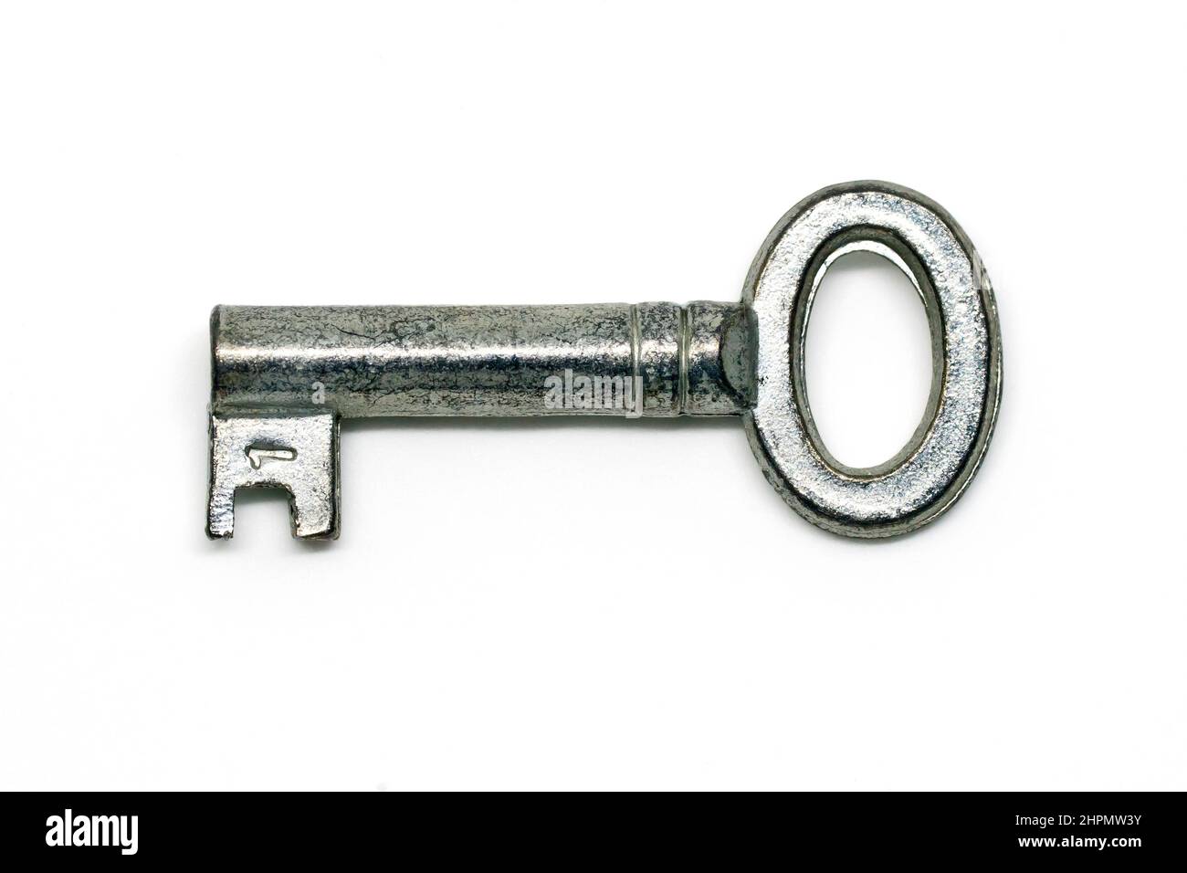 Close up of a small silver key, simple and classic design, isolated ...