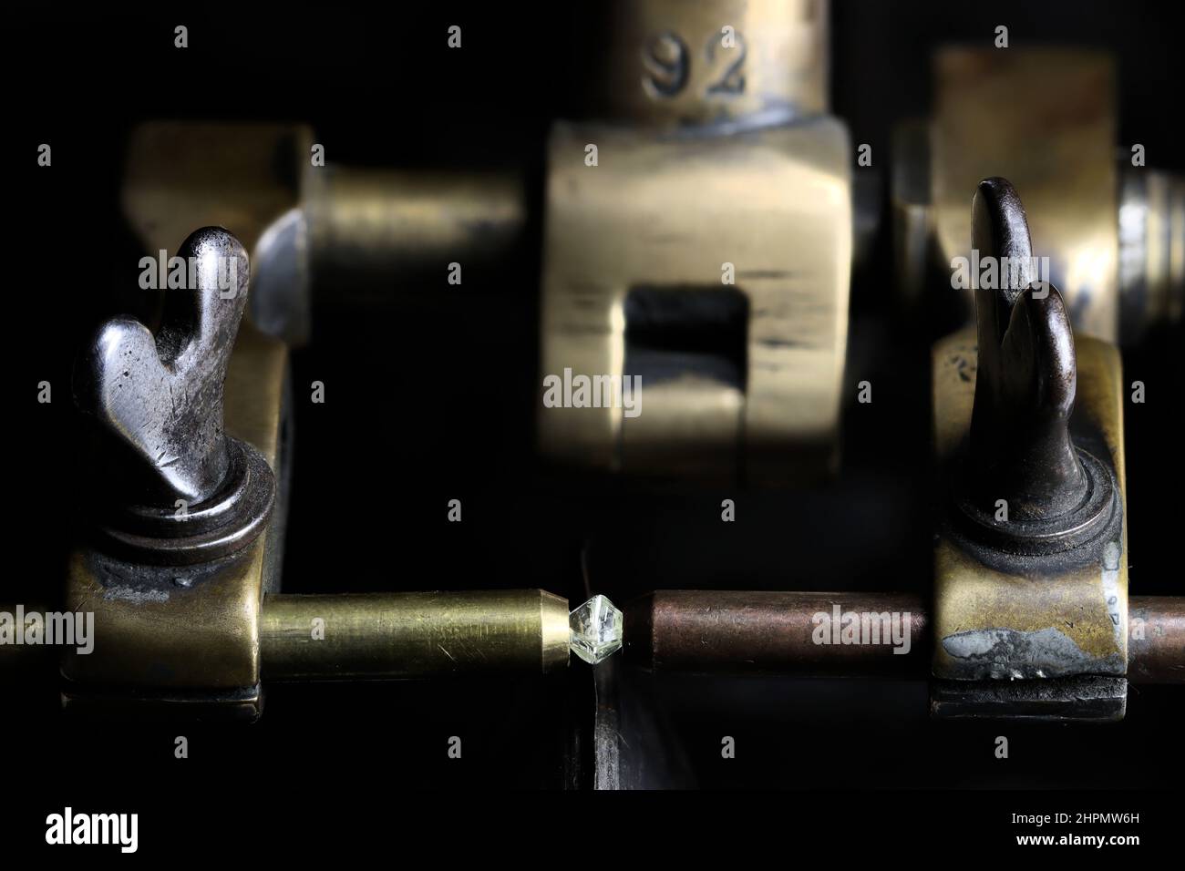 0.55 ct octahedral diamond crystal clamped in a vintage diamond cutting ...