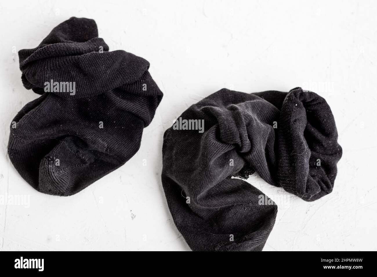 Dirty old socks on a white background. Wrinkled worn men's black socks ...