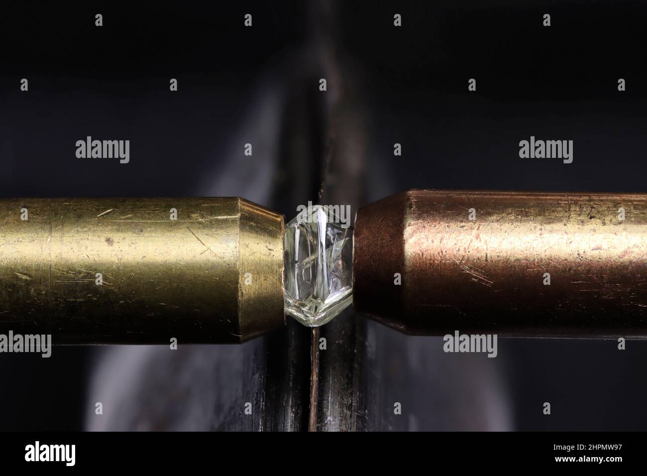 0.55 ct octahedral diamond crystal clamped in a vintage diamond cutting ...