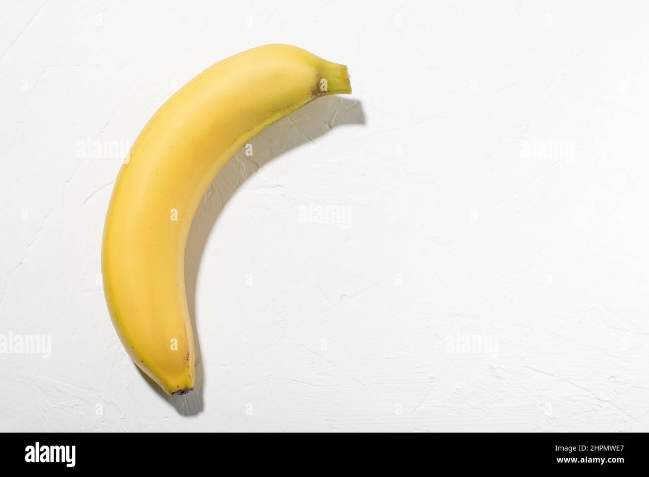 Banana on a white background. Whole unpeeled natural banana Stock Photo ...