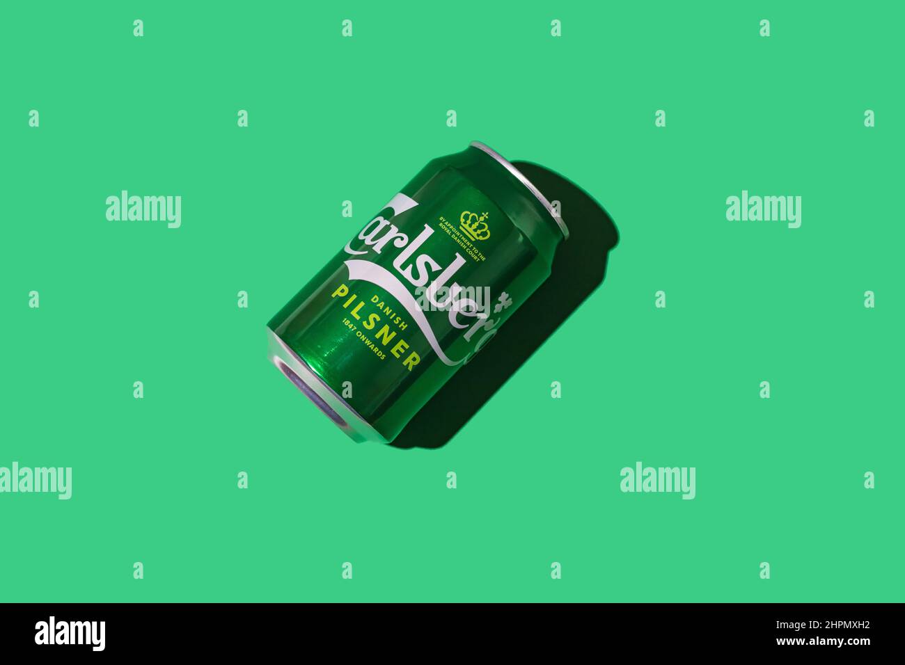 Green can of Dutch Heineken beer with hard shadow on white background ...