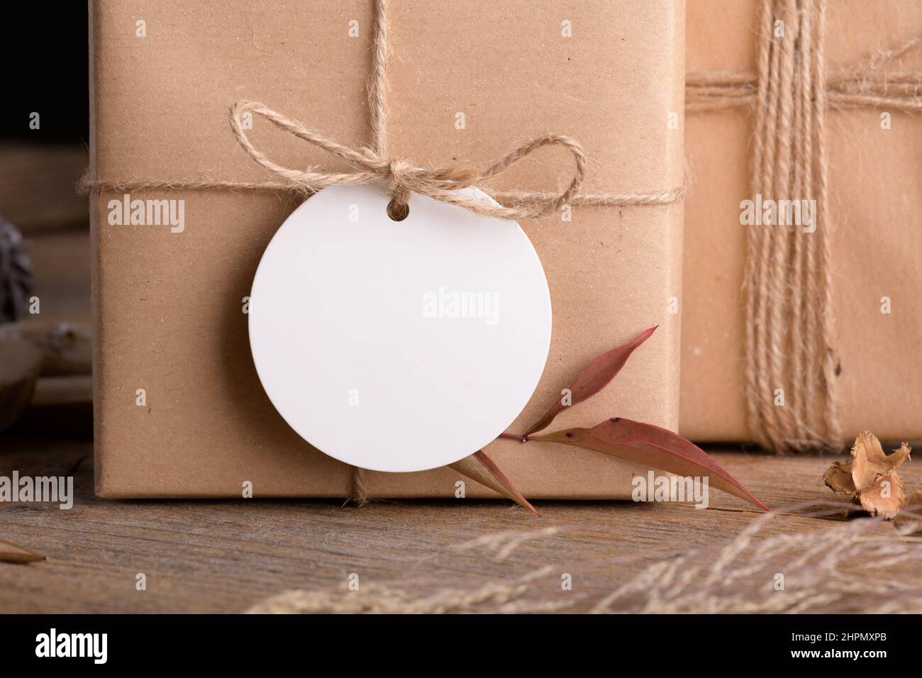 Round white gift tag mockup on Christmas or Valentines Day wrapped ...