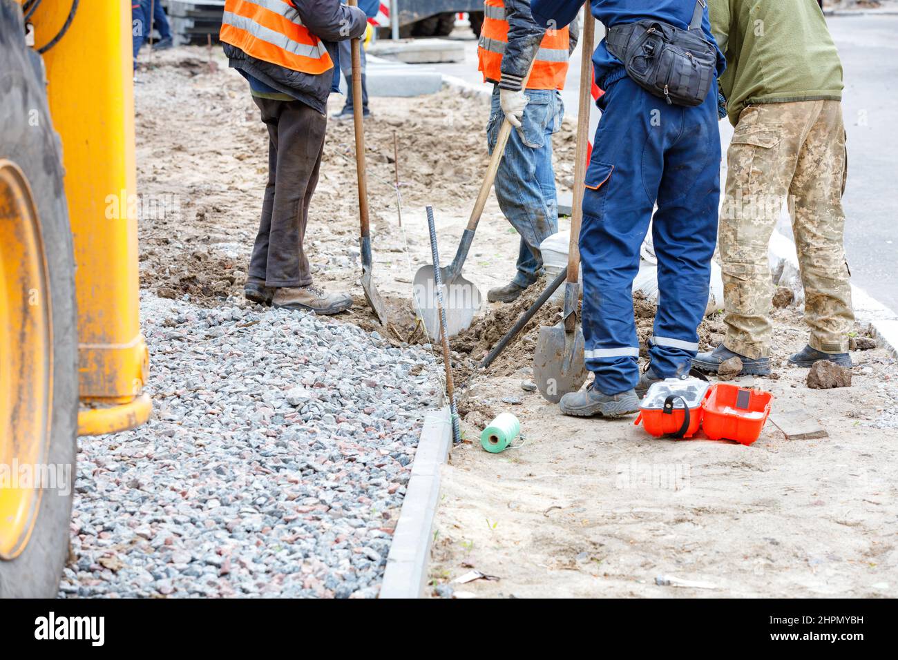 The construction of a new pavement by a group of builders who are ...