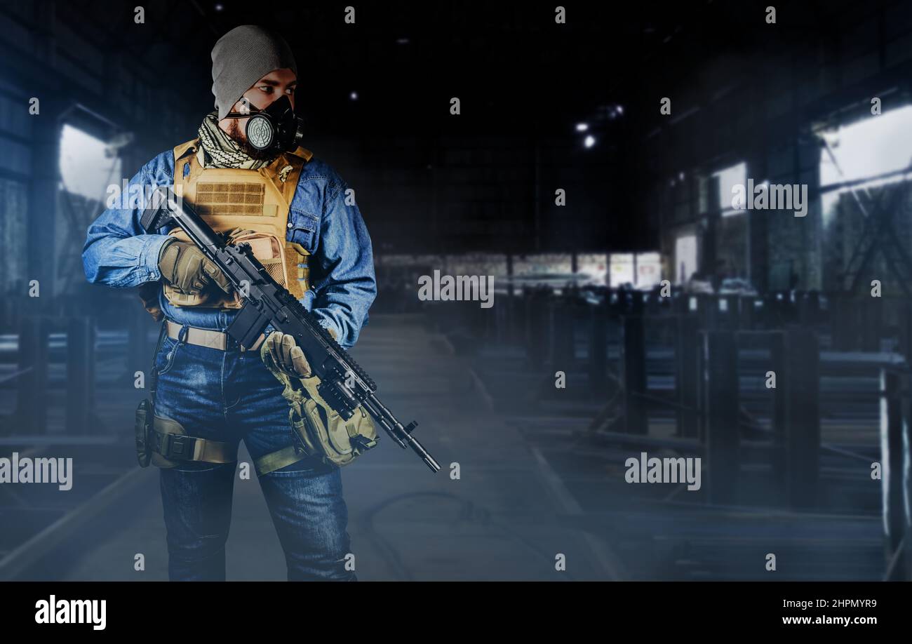 Photo of urban soldier in tactical military outfit and gas mask ...