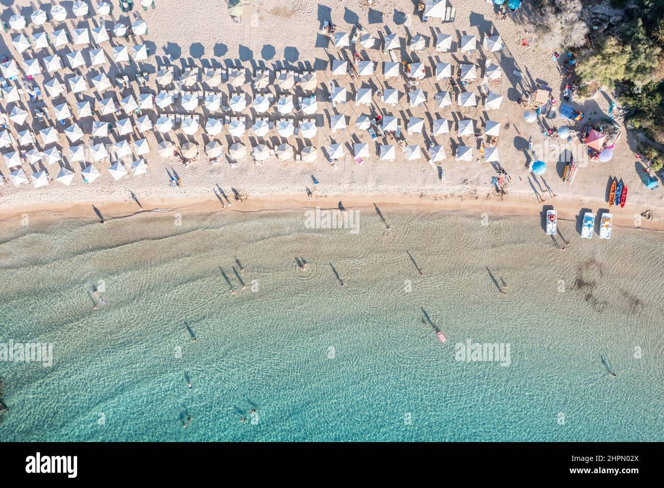 Greece, sandy beach, aerial drone view. People swim and relax at ...