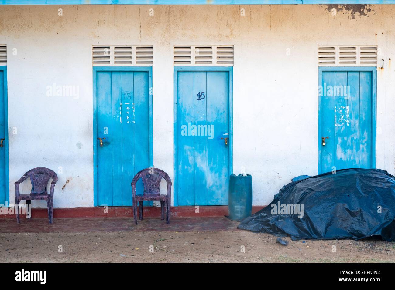 three blue doors with a white wall Stock Photo - Alamy