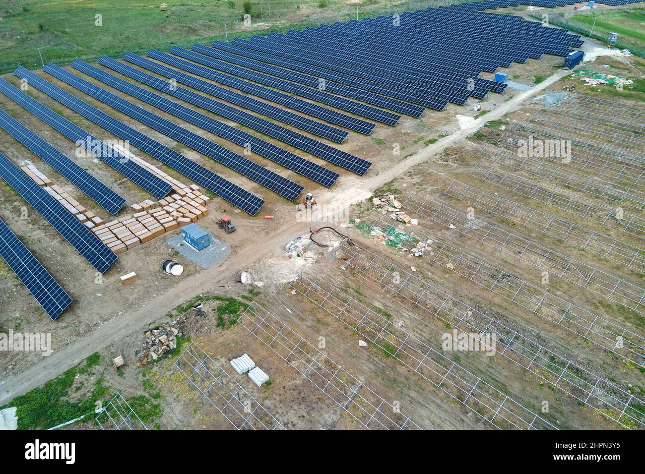 Aerial view of big electric power plant under construction with many ...