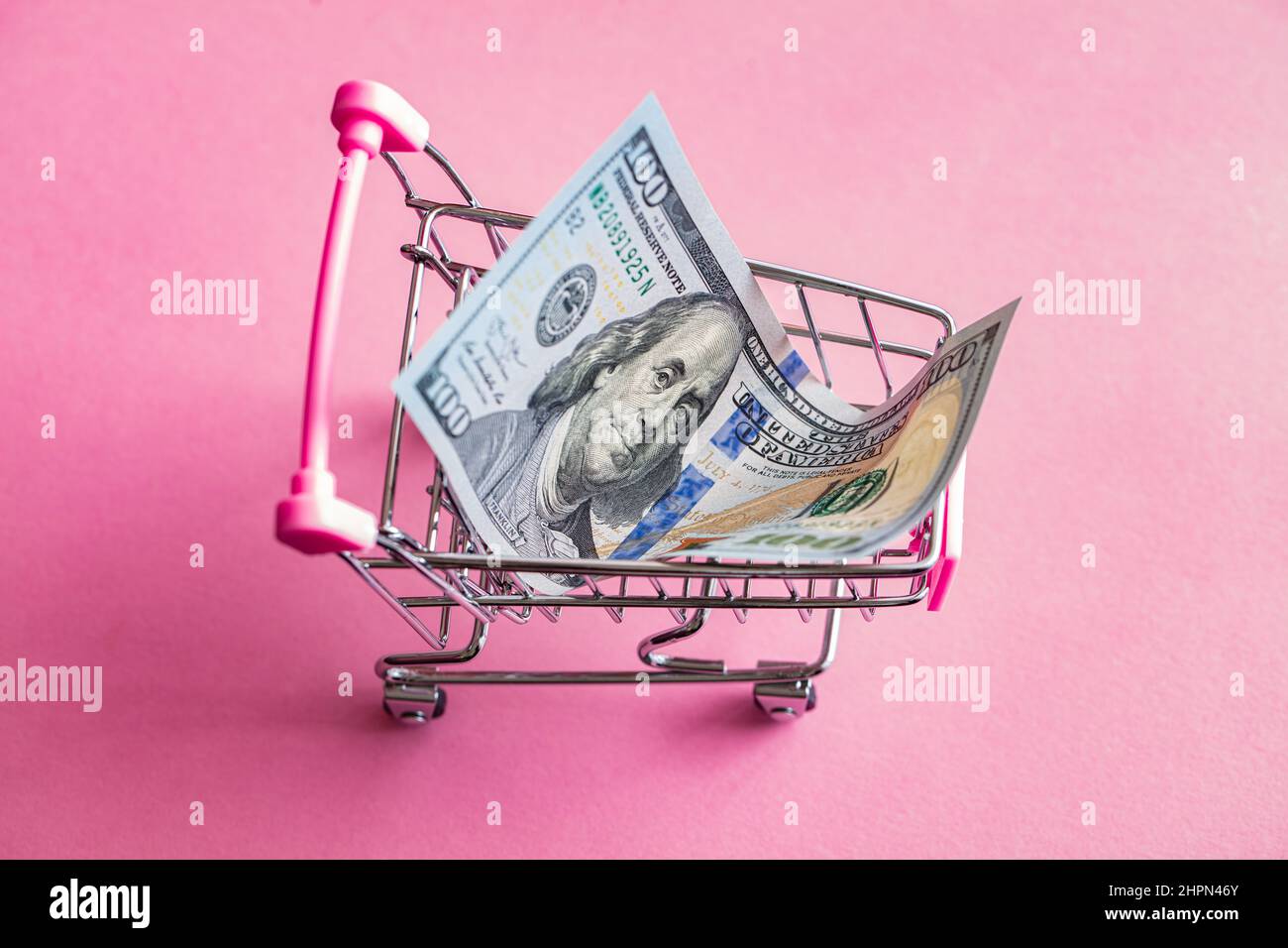 Small shopping cart with 100 dollar banknote for design purpose Stock ...