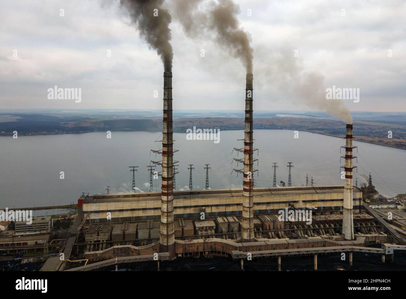 Aerial view of coal power plant high pipes with black smoke moving up ...