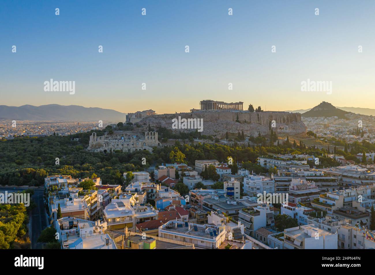 Aerial view of quarters of Greek capital at dawn, against backdrop of ...