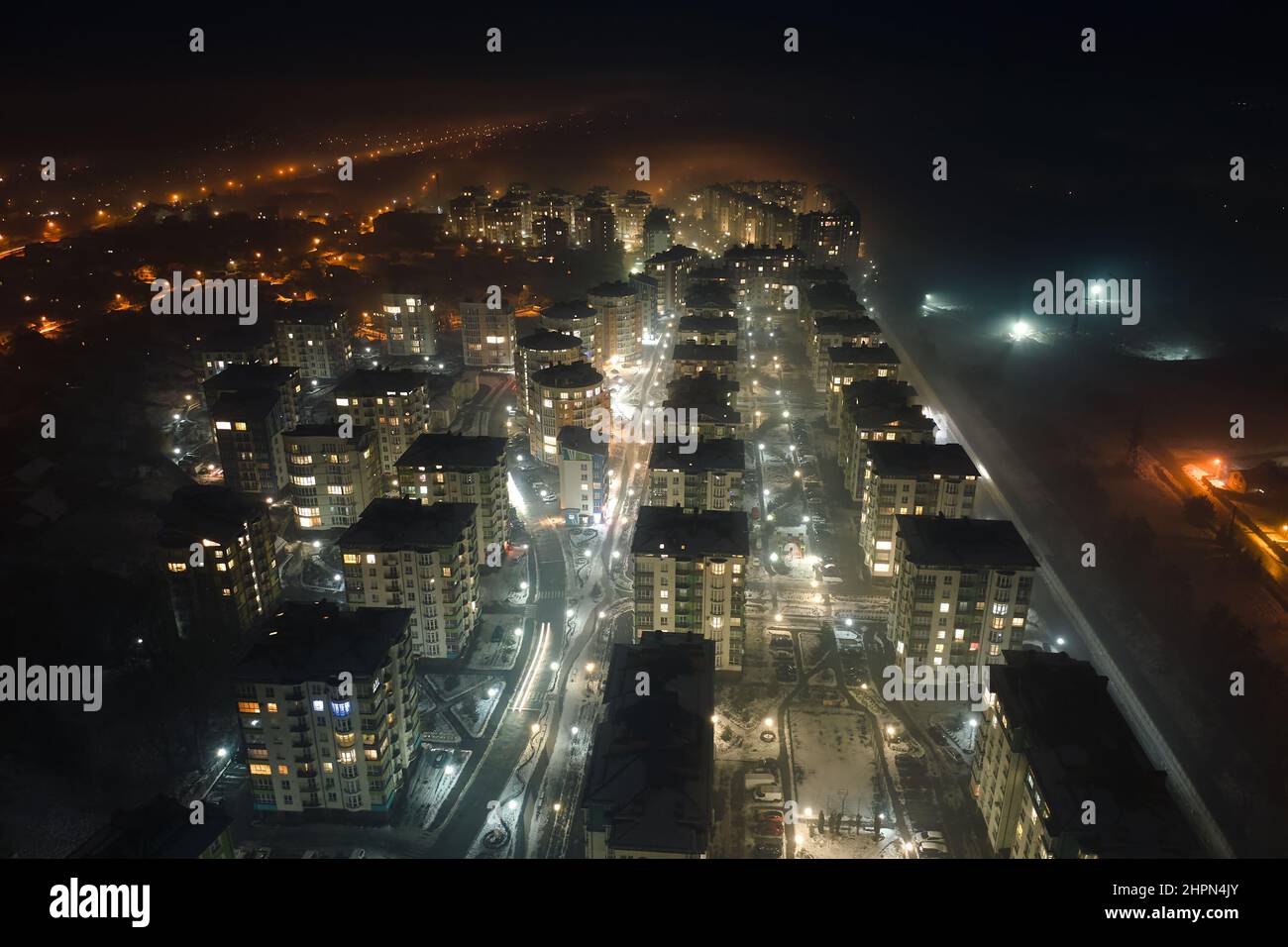 Aerial view of high rise apartment buildings and bright illuminated ...