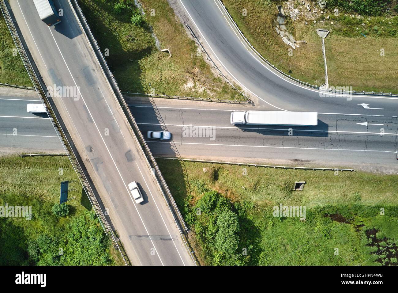 Aerial view of road intersection with fast moving heavy traffic on city ...