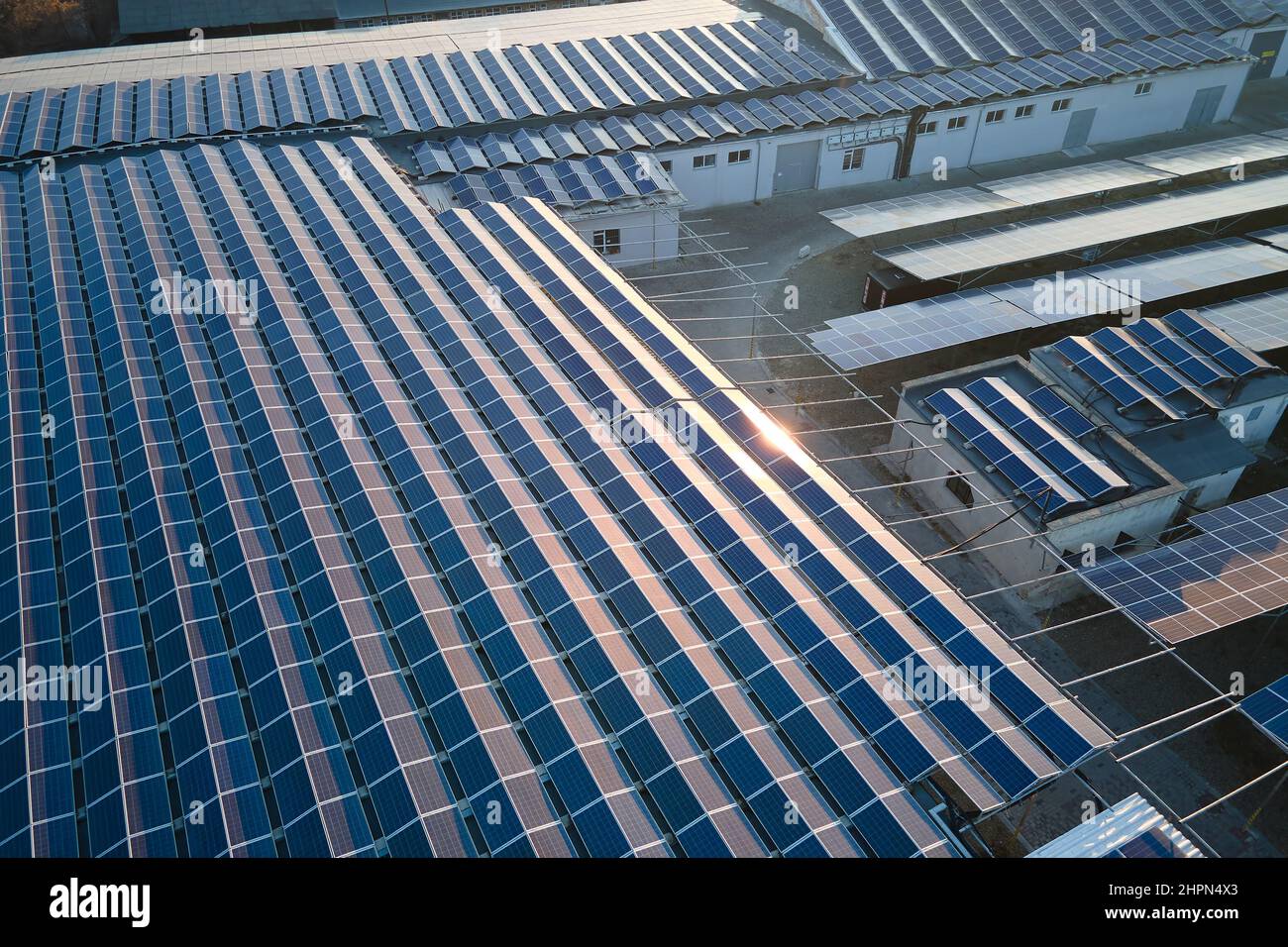 Aerial view of solar power plant with blue photovoltaic panels mounted ...