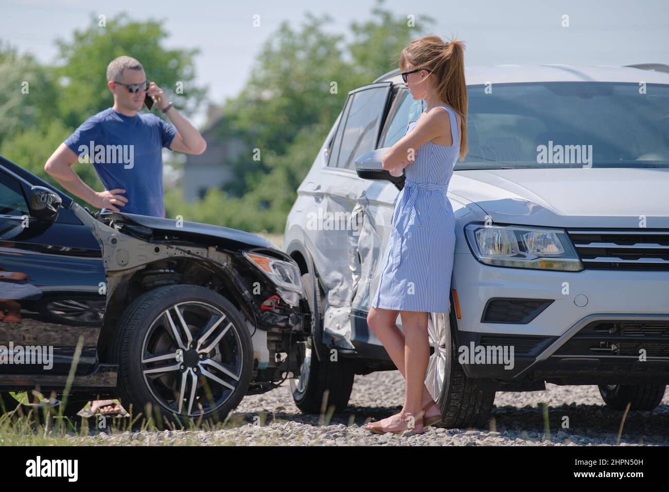 Angry woman and man drivers of heavily damaged vehicles calling ...