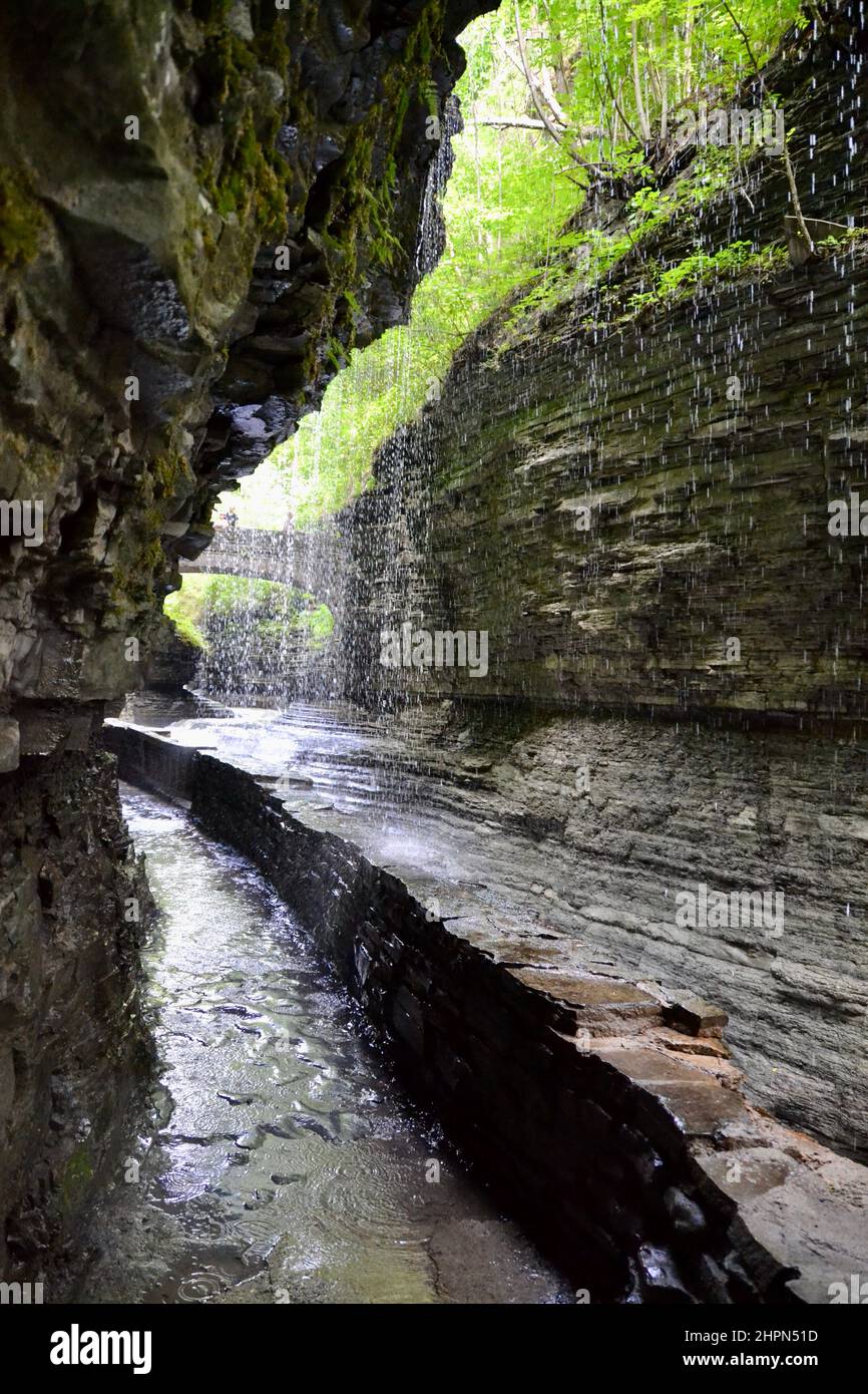 Water falling from limestone cliff overhang at Watkins Glen during ...