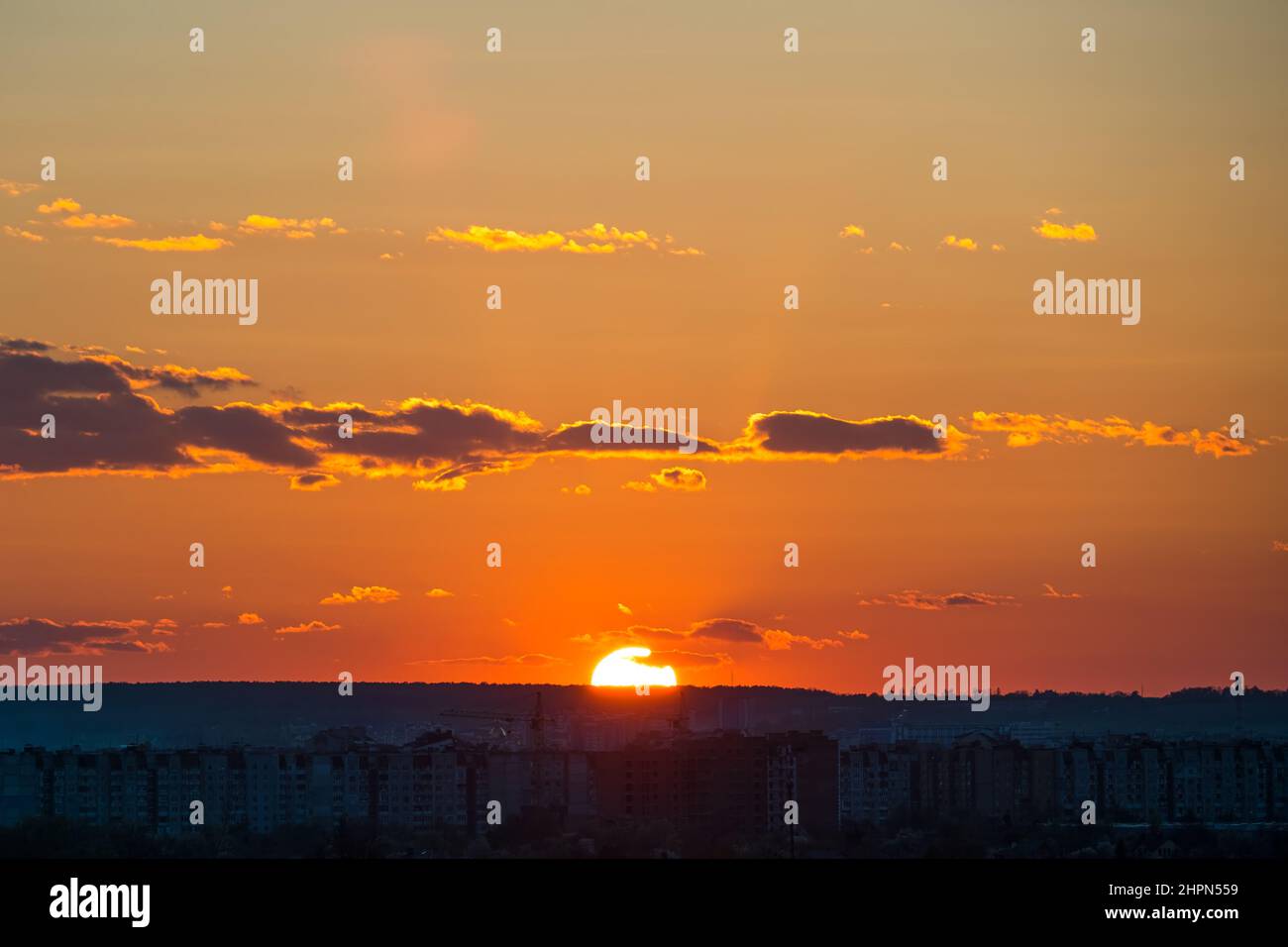 Bright colorful sunset sky with rays of setting sun and vivid dark ...