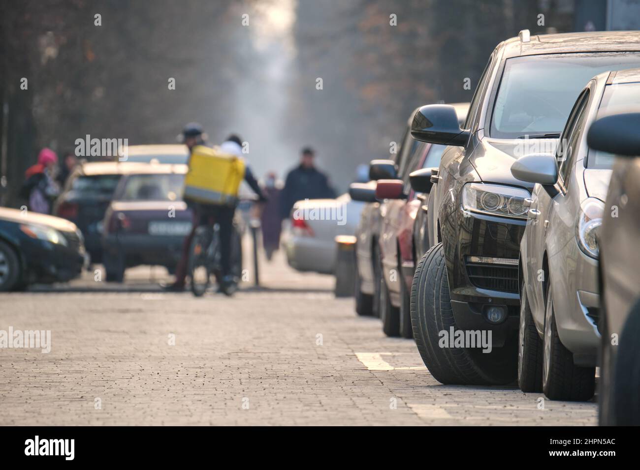 City traffic with cars parked in line on street side Stock Photo - Alamy
